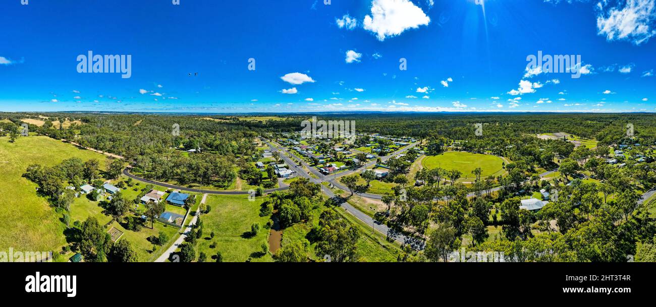 Aerial View of the town of Gilgai surrounded by green rainforests in ...