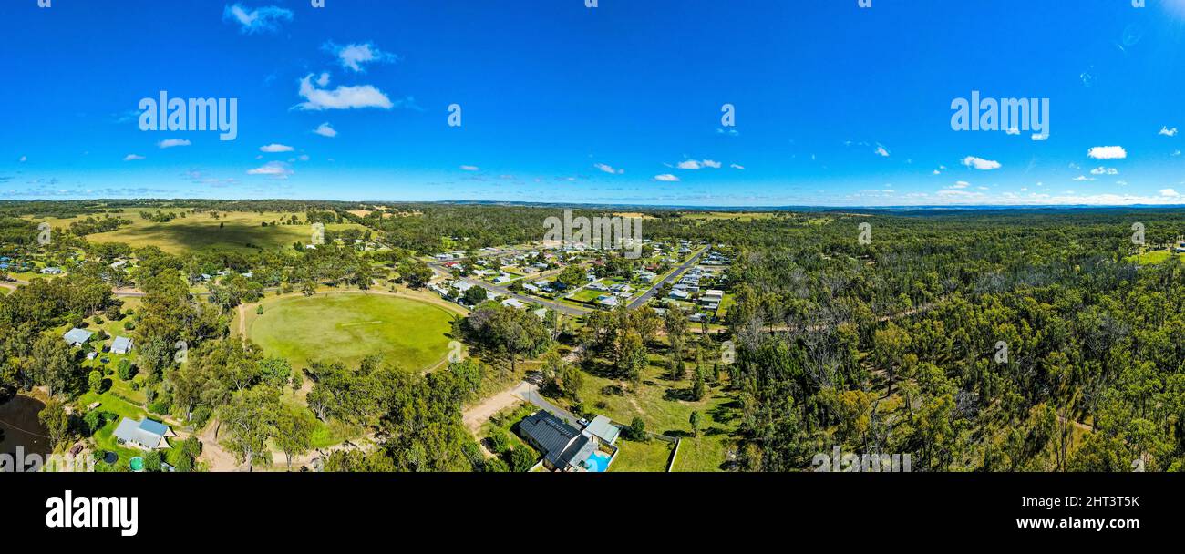 Aerial View of the town of Gilgai surrounded by green rainforests in ...