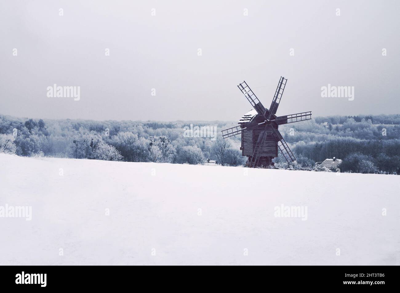 Panoramic shot of beautiful windmill covered in snow on a cold snowy ...