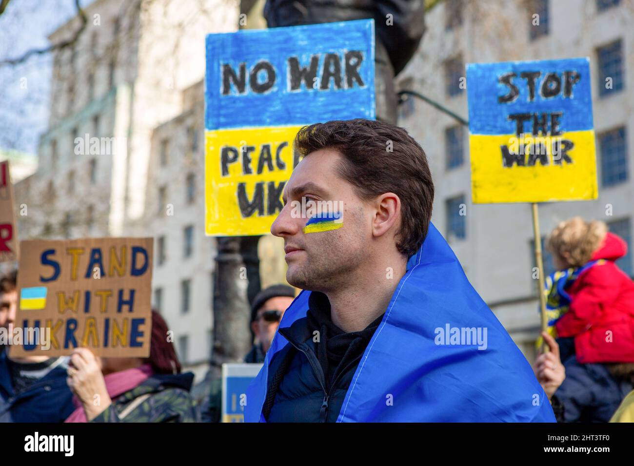 London, UK. 26th Feb, 2022. A Protester has his face painted in yellow ...
