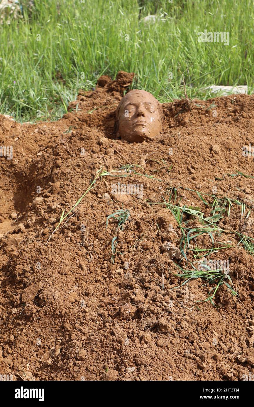 A woman buried in the ground A face covered in the ground Stock Photo ...