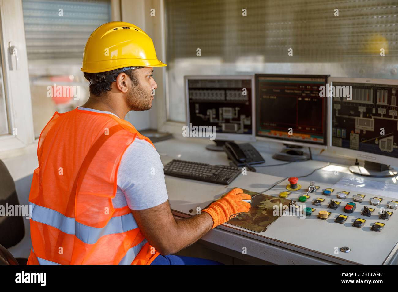Young multiethnic operator working at concrete plant Stock Photo - Alamy