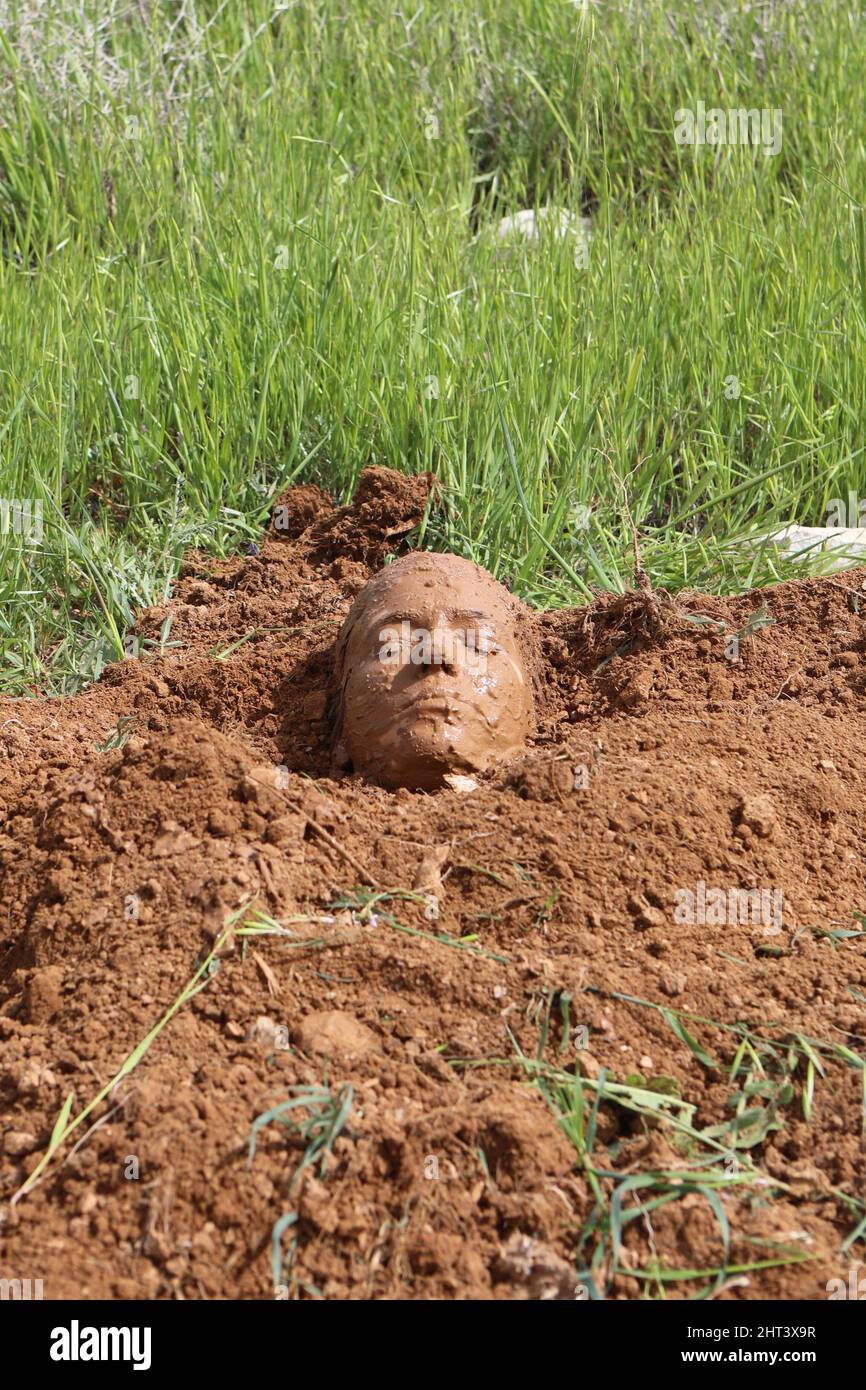 A woman buried in the ground A face covered in the ground Stock Photo ...