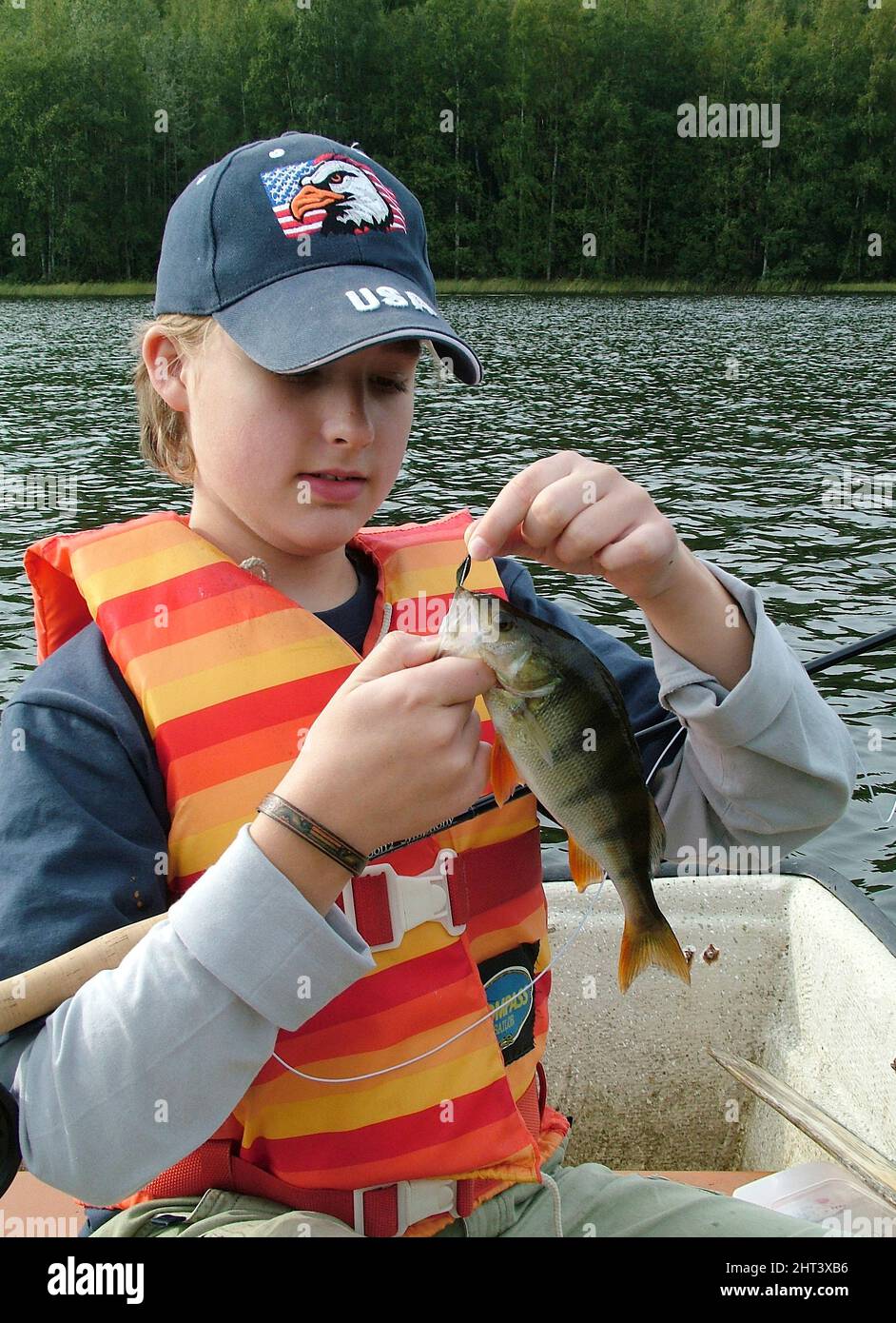 Boy with perch catch Stock Photo - Alamy