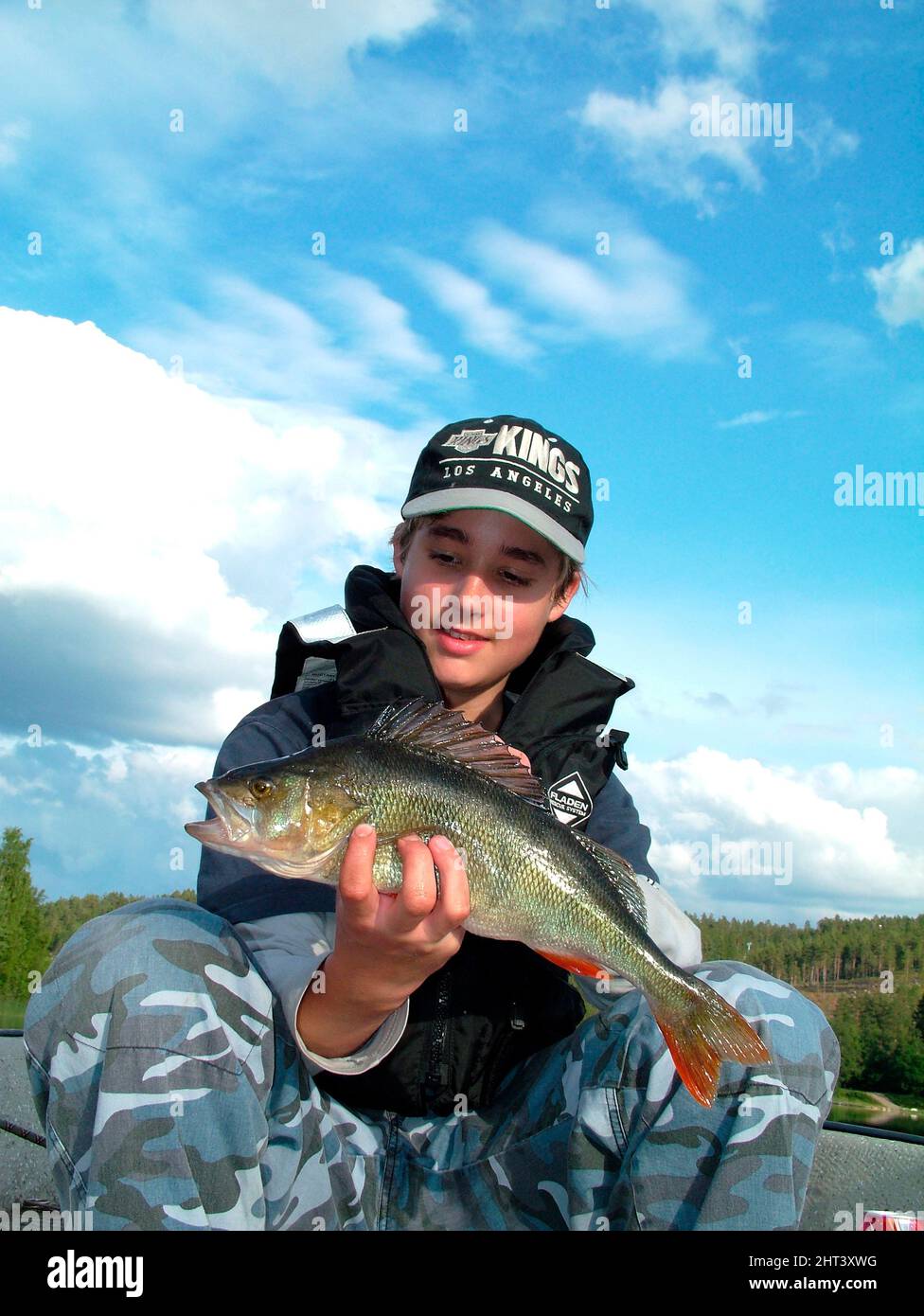 Happy boy with perch catch Stock Photo - Alamy