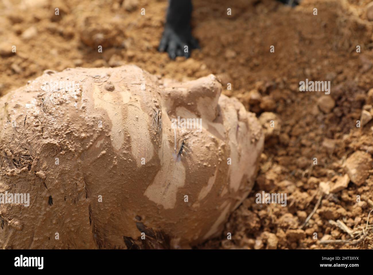 A woman buried in the ground A face covered in the ground Stock Photo ...