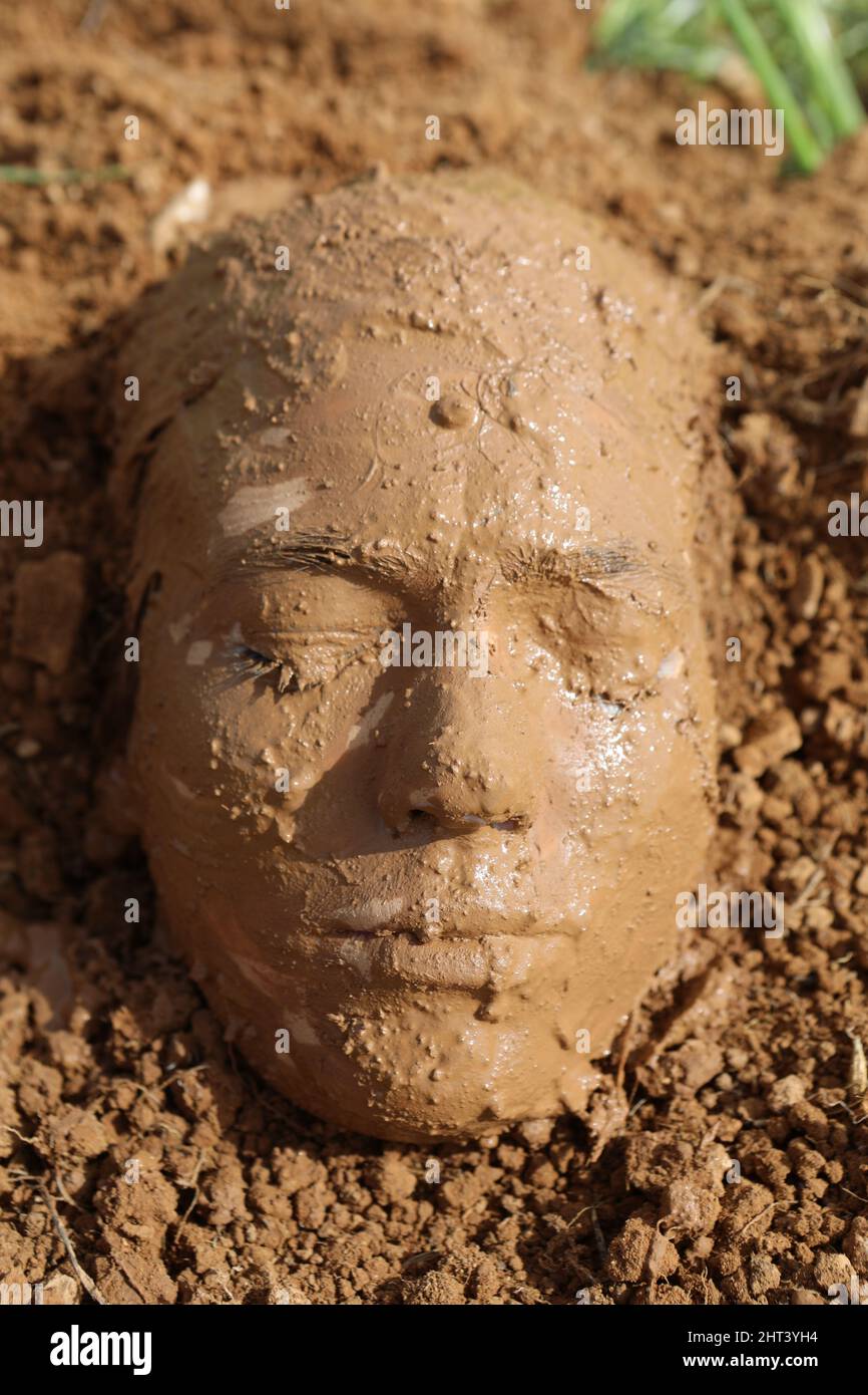 A woman buried in the ground A face covered in the ground Stock Photo ...