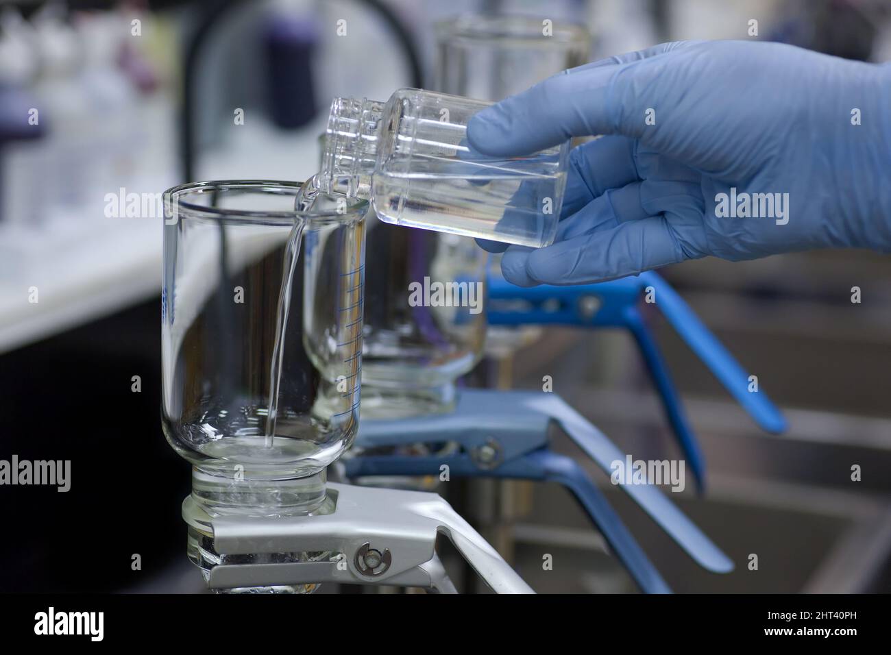 Scientist pouring a water sample into a membrane filter Stock Photo - Alamy