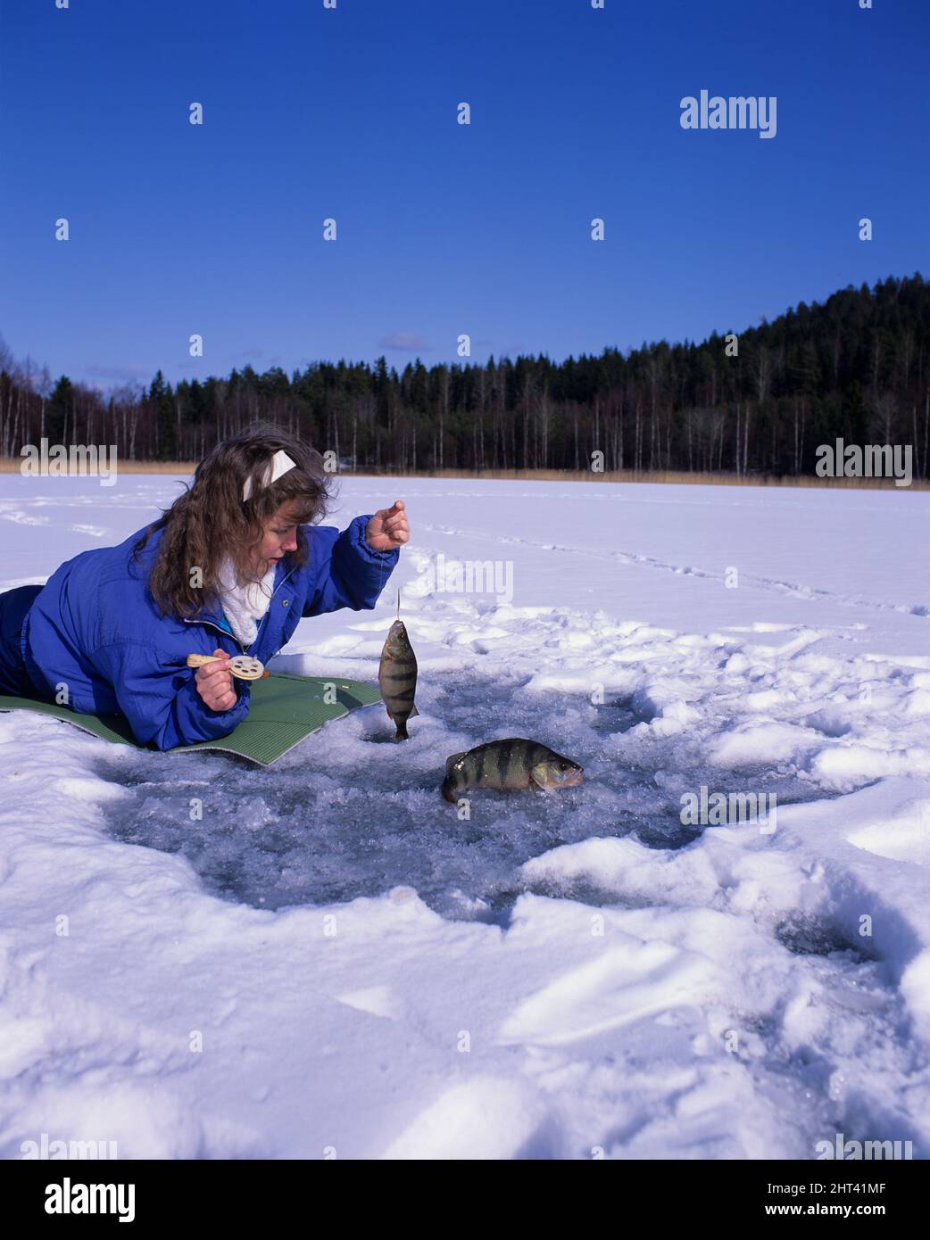 Woman ice fishing hi-res stock photography and images - Alamy