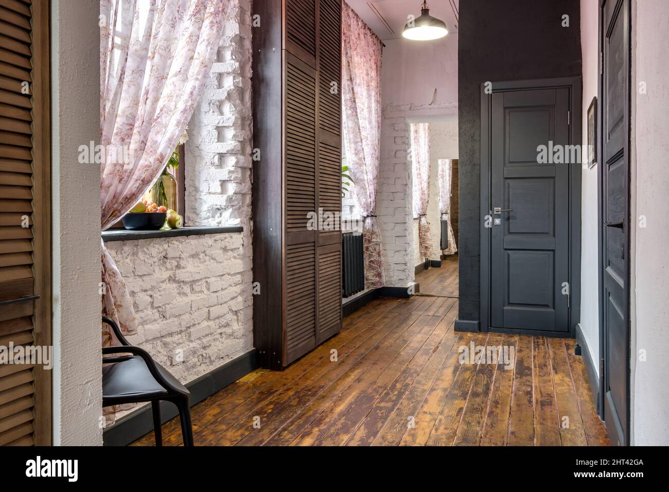 long corridor in interior of entrance hall of modern apartments with ...
