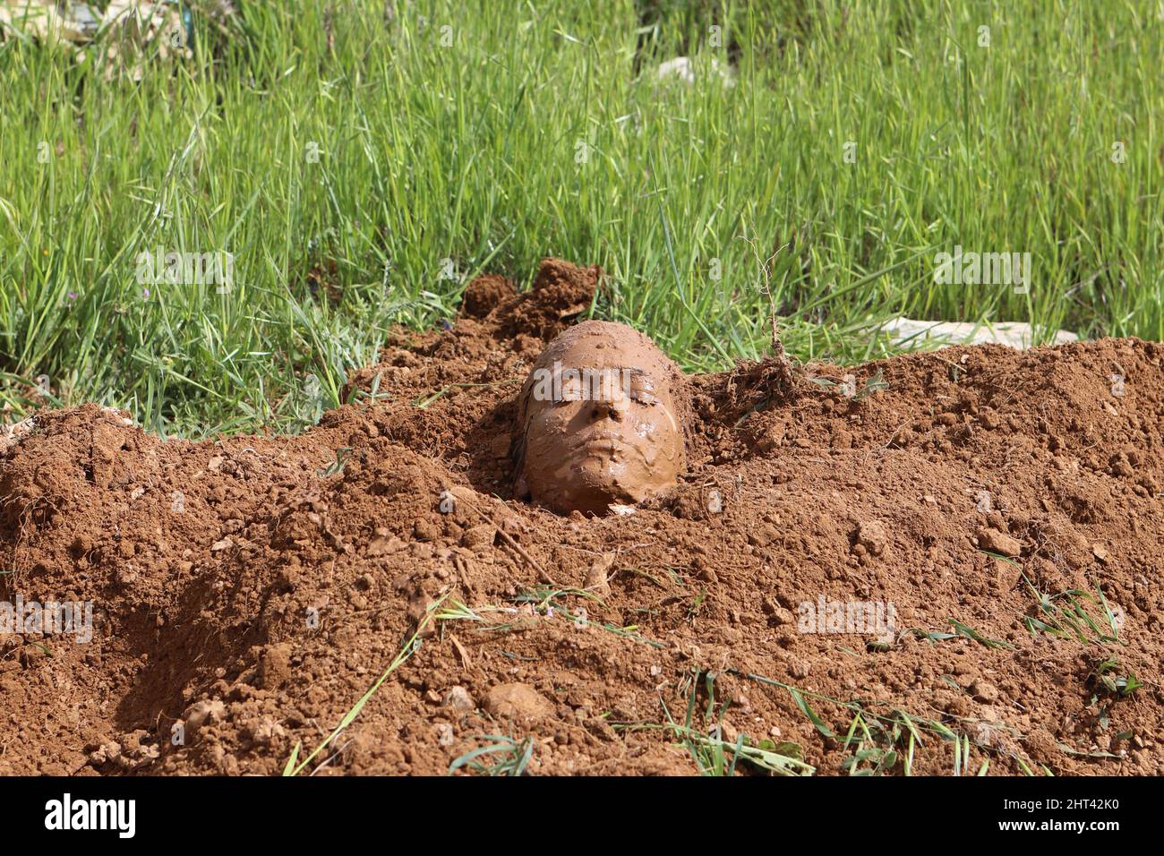 A woman buried in the ground A face covered in the ground Stock Photo ...