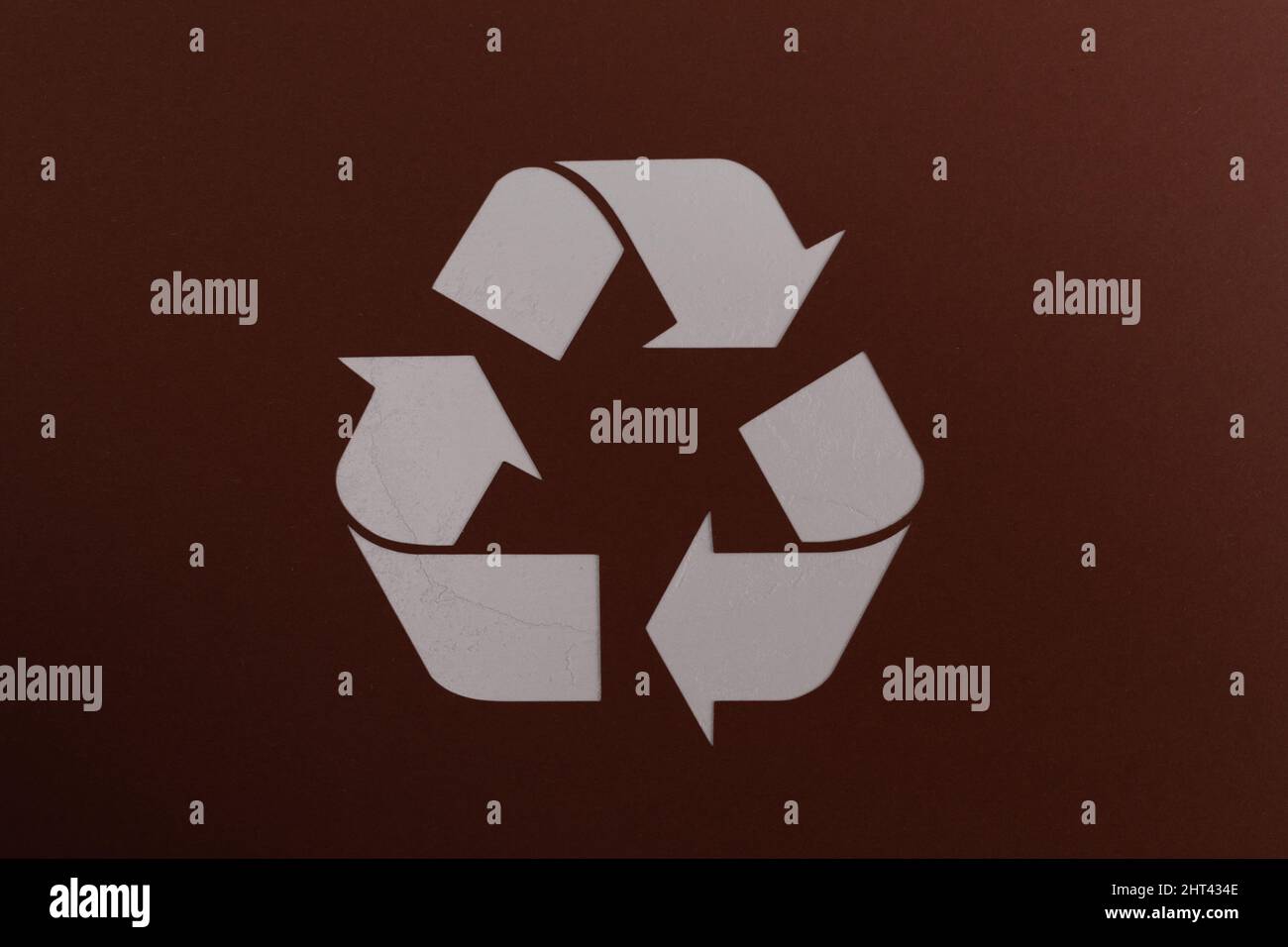 Recycling symbol on a brown background Stock Photo - Alamy