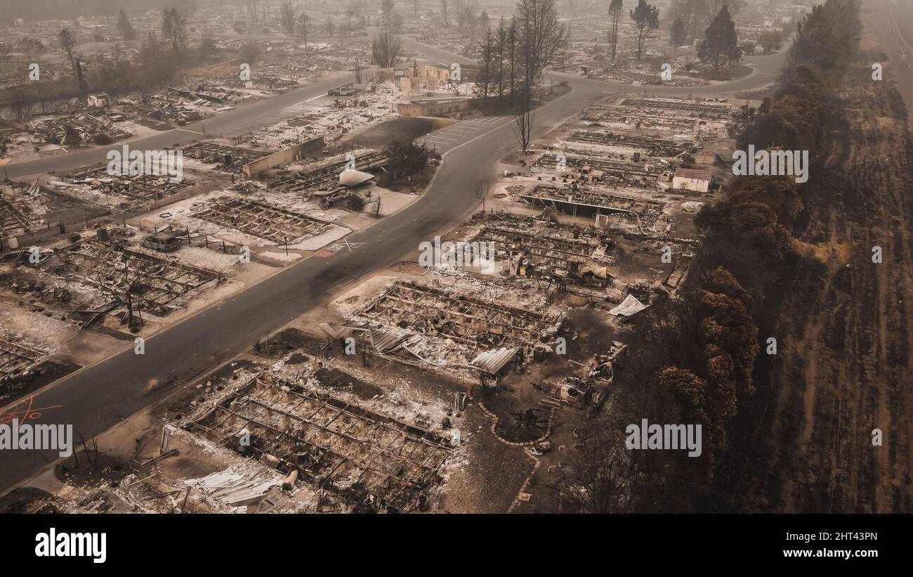 Street running through a mobile home park ruined by arson wildfire ...