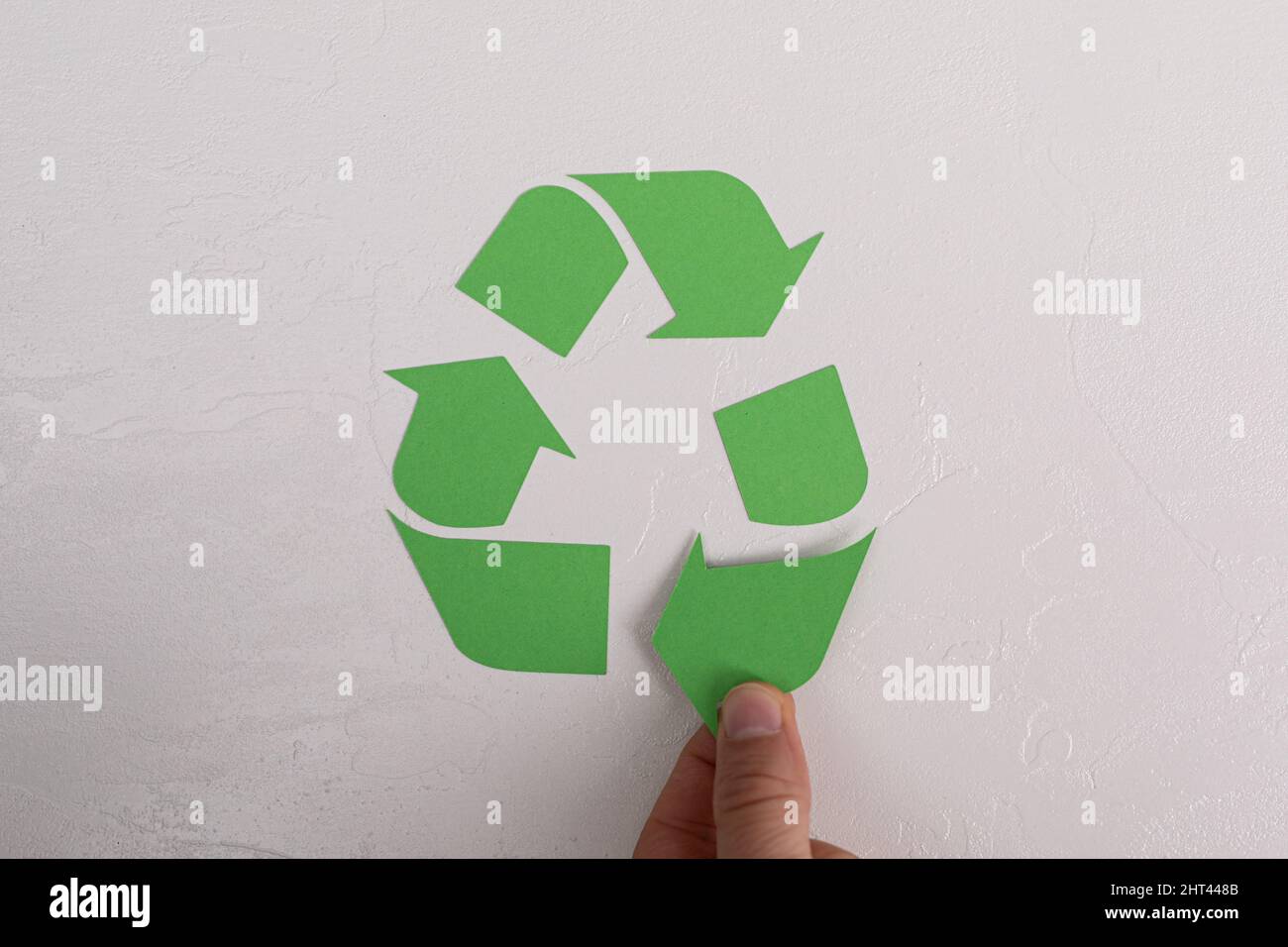 Person attaching the symbol of recycling to a wall Stock Photo - Alamy