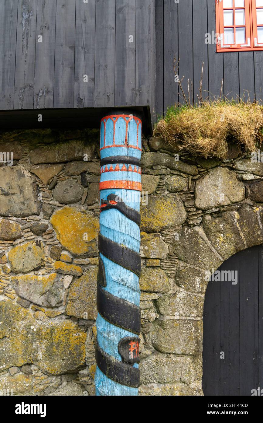 Closeup of a metal pipe supporting one of the oldest inhabited wooden ...