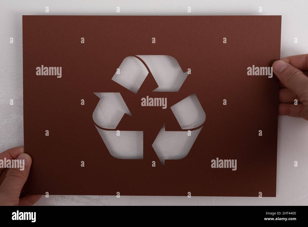 Symbol of recycling on a brown board Stock Photo - Alamy