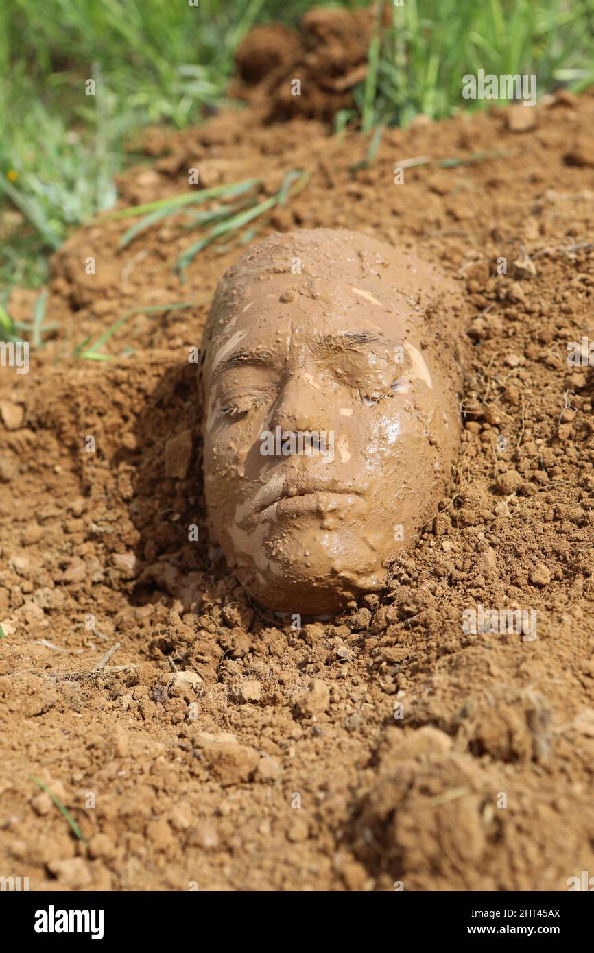 A woman buried in the ground A face covered in the ground Stock Photo ...