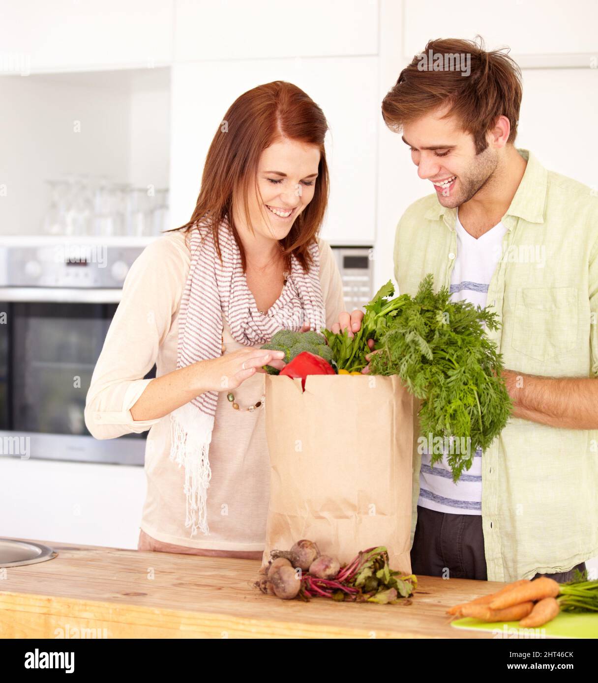 Lets pack these away. A happy couple in the kitchen with their newly ...