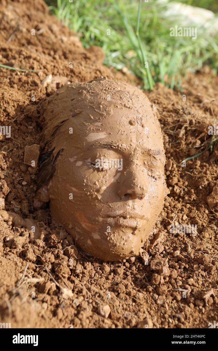 A woman buried in the ground A face covered in the ground Stock Photo ...