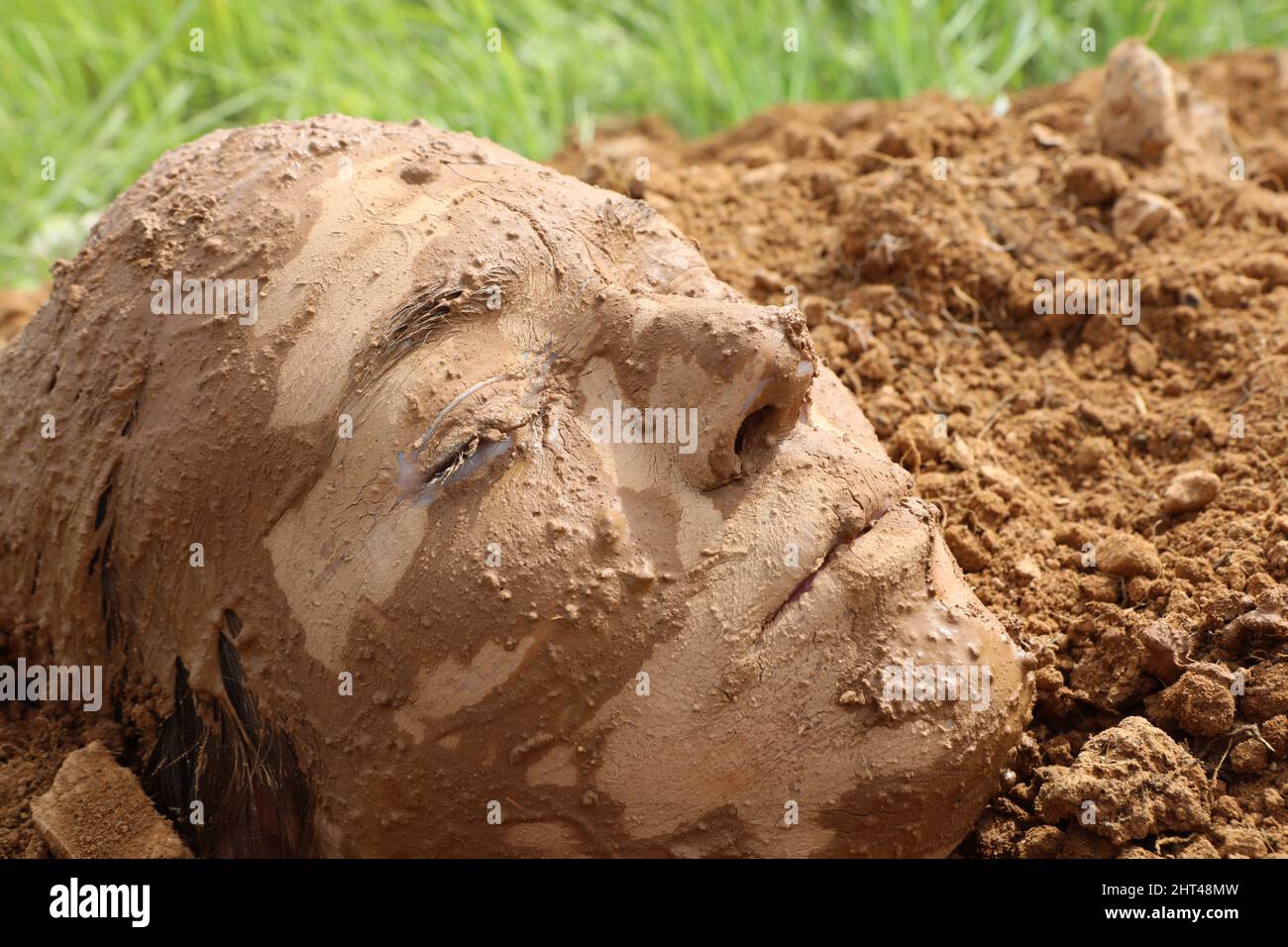 A woman buried in the ground A face covered in the ground Stock Photo ...