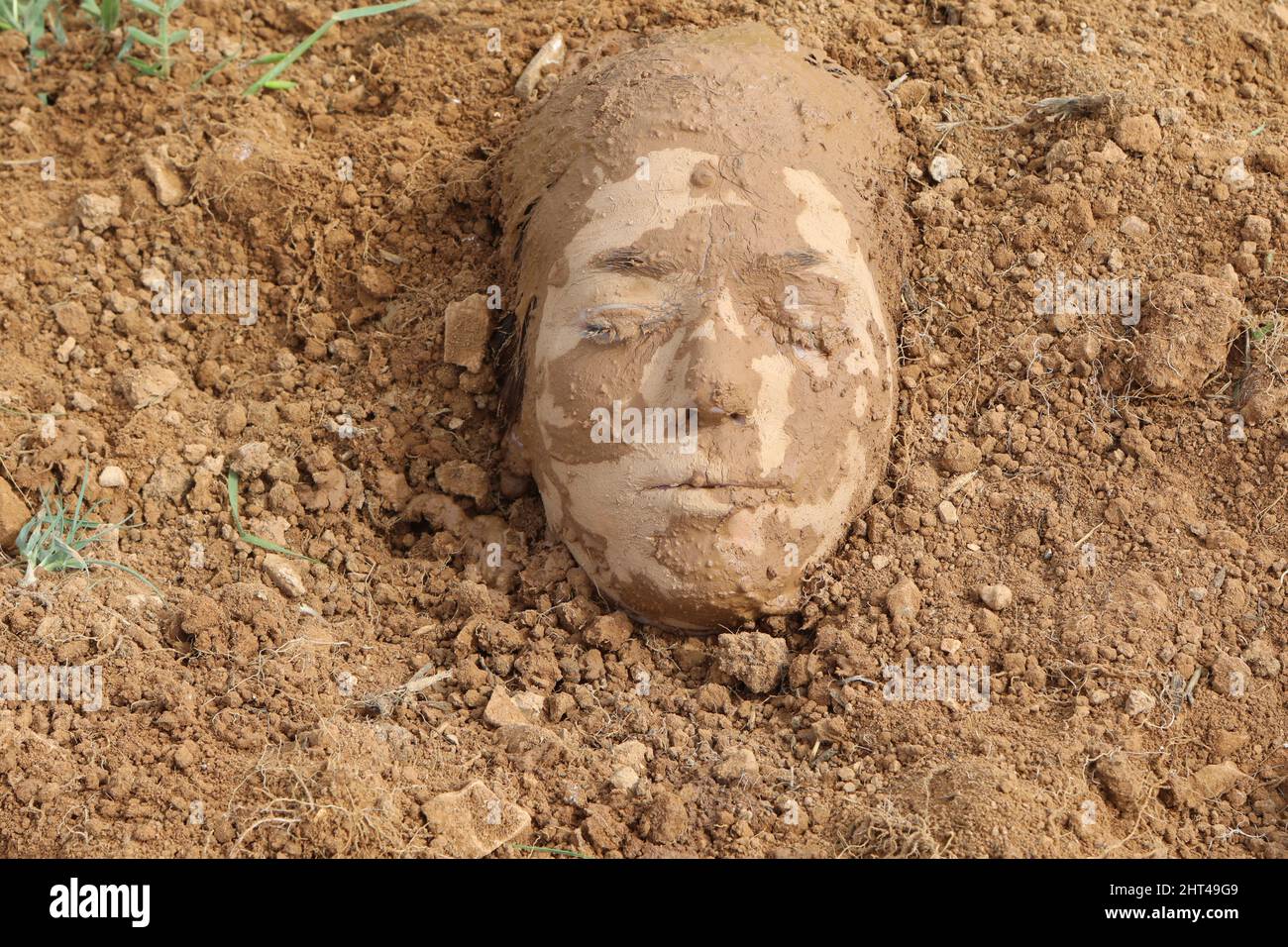 A woman buried in the ground A face covered in the ground Stock Photo ...