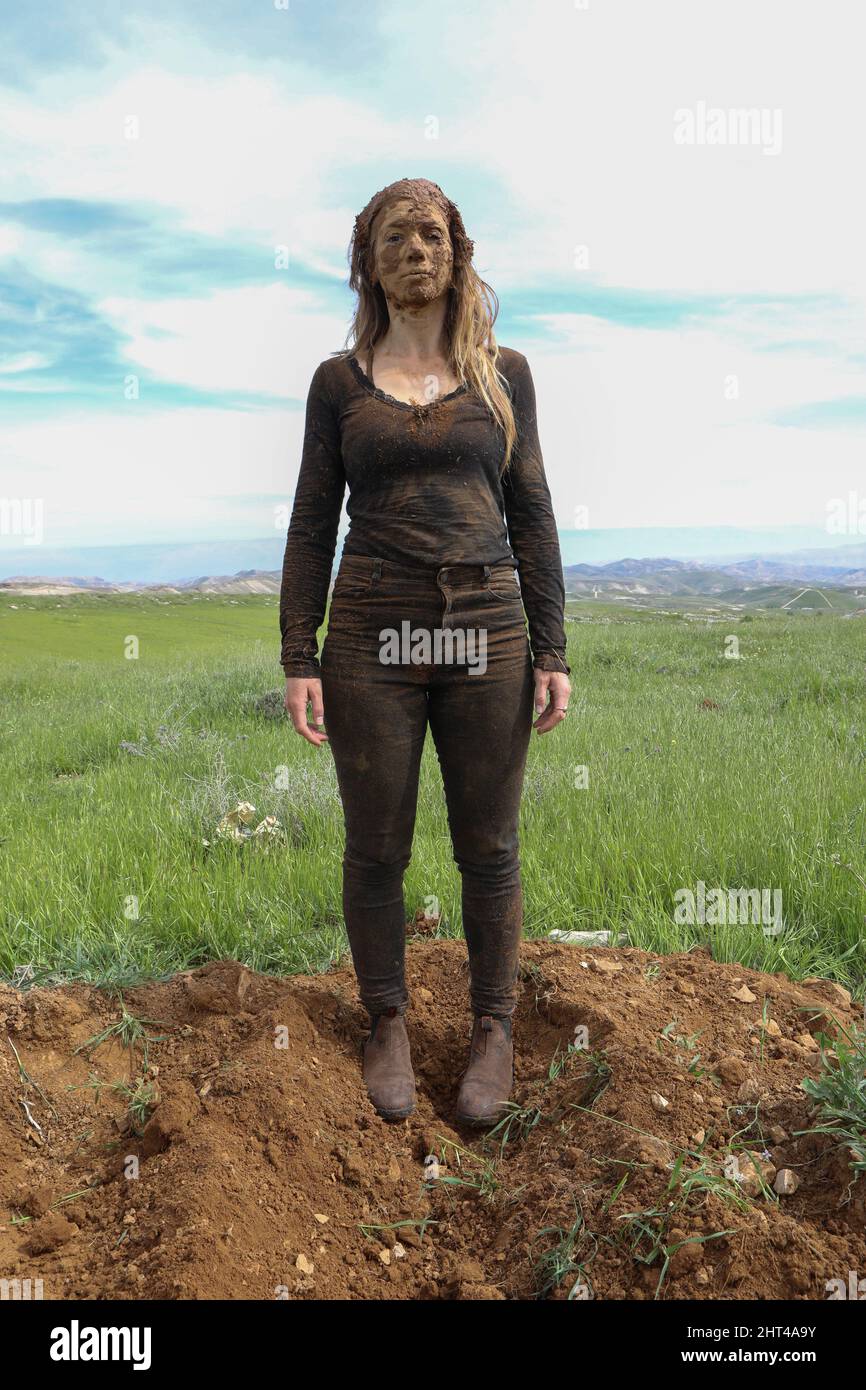 A woman buried in the ground A face covered in the ground Stock Photo ...