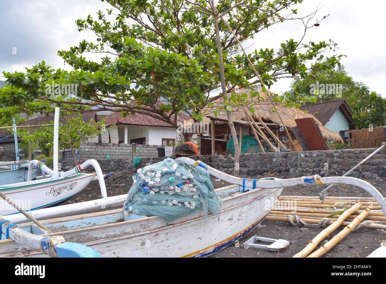 Fishing boats and nets on Bali beach Stock Photo - Alamy