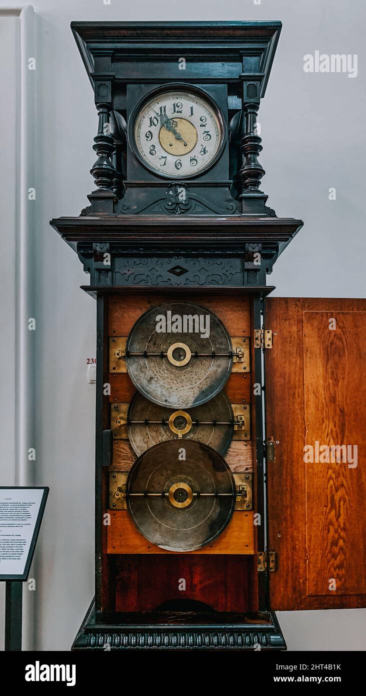 Vintage wall clock with metallic shields on it displayed in the museum ...