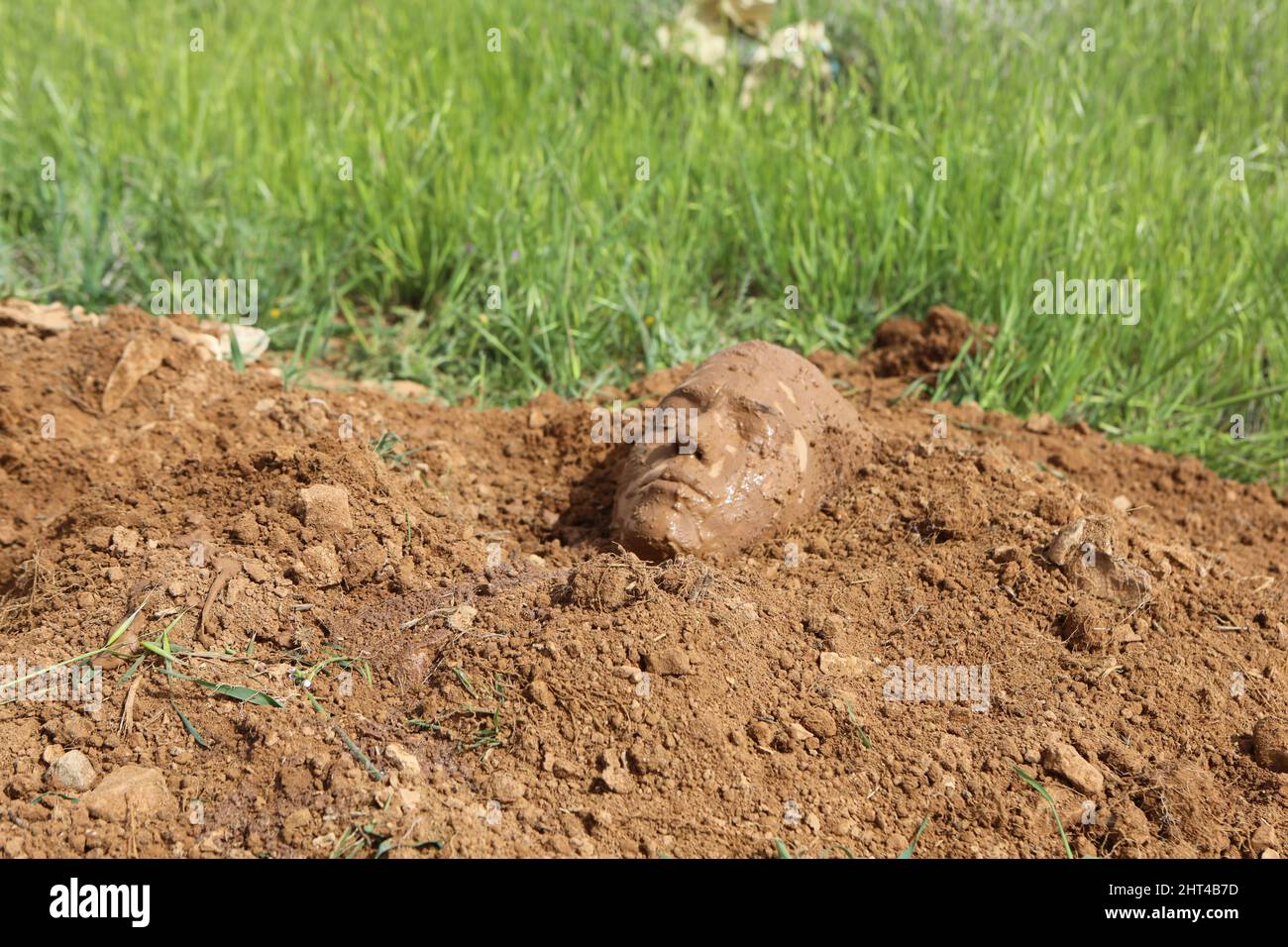 A woman buried in the ground A face covered in the ground Stock Photo ...