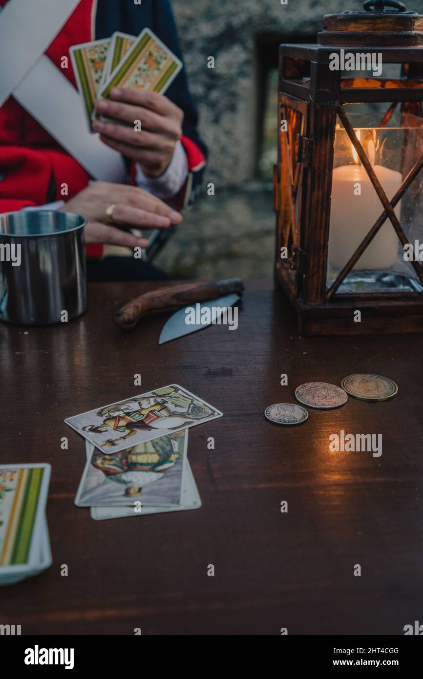 Vertical photo of a soldier sitting around a wooden table and playing ...
