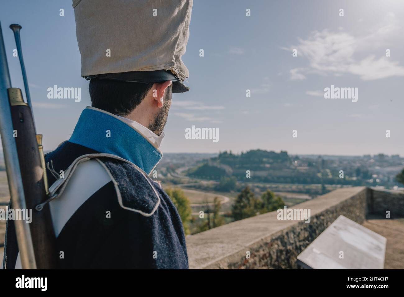 Photo of a soldier from behind standing alone and guarding an area ...