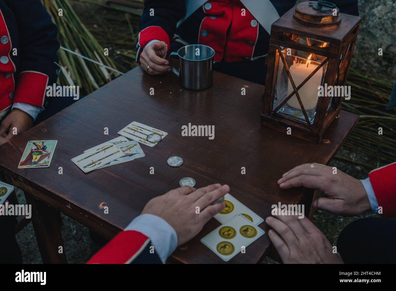 Photo of soldiers sitting around a wooden table and playing a game ...