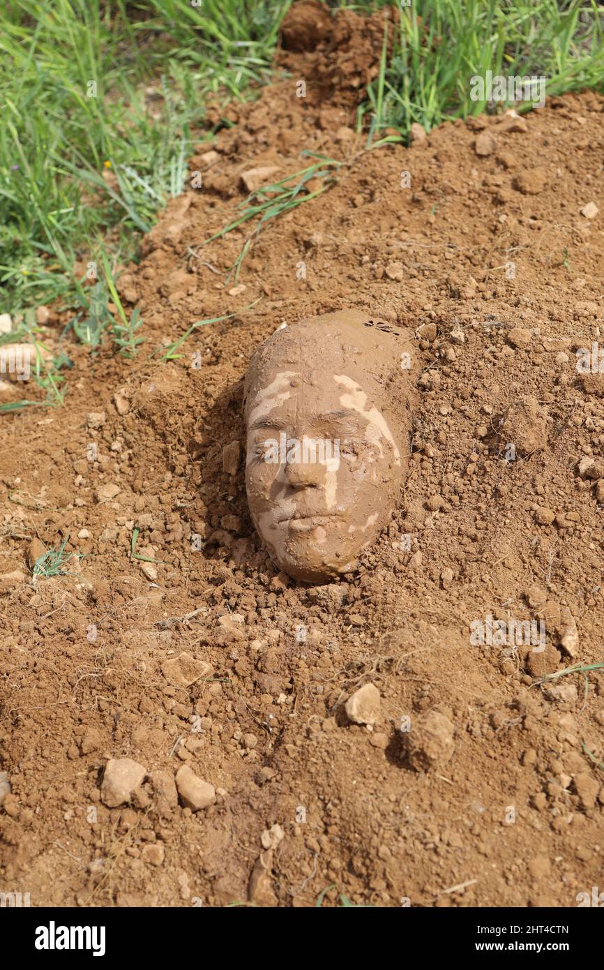 A woman buried in the ground A face covered in the ground Stock Photo ...