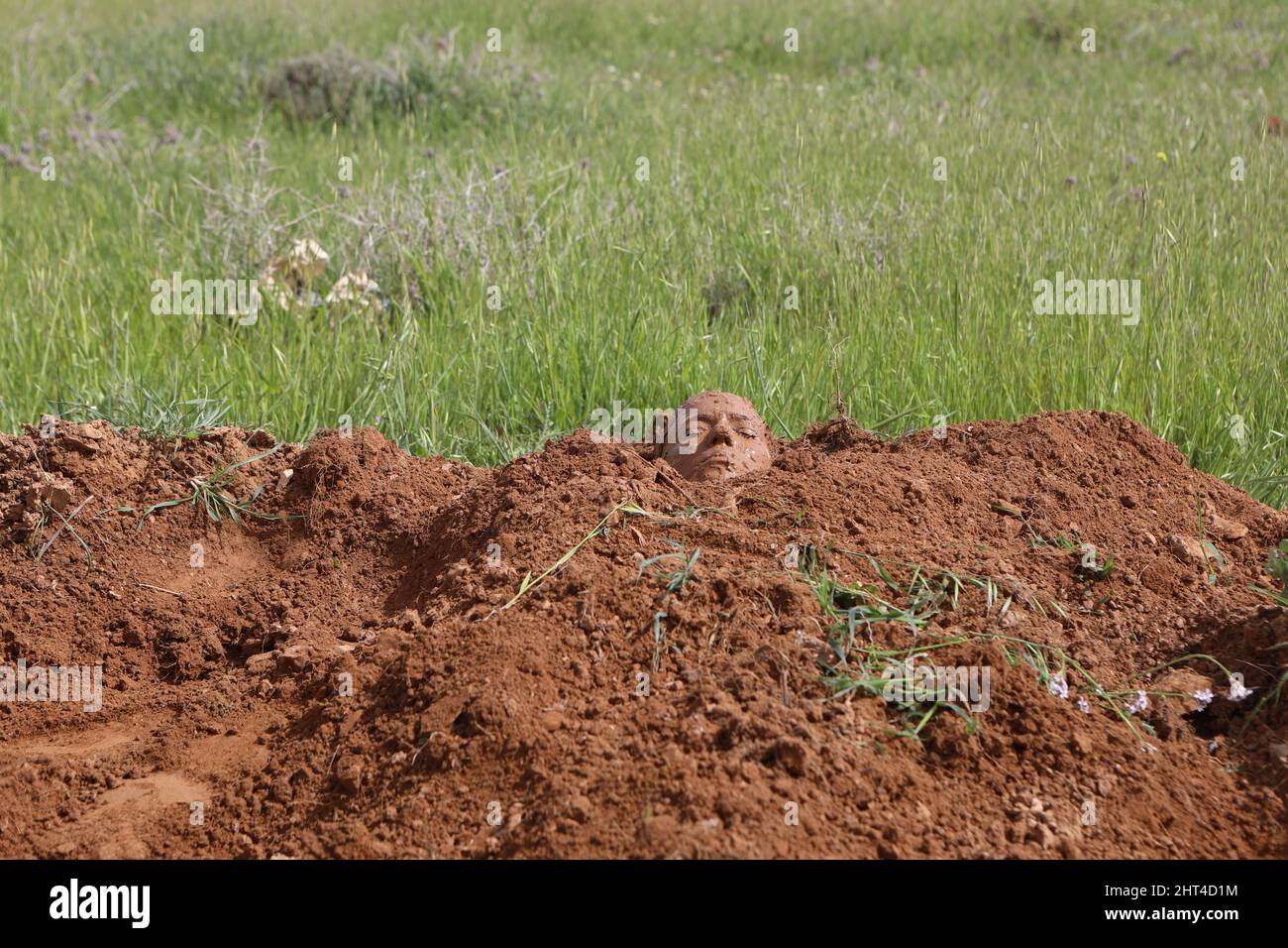 A woman buried in the ground A face covered in the ground Stock Photo ...