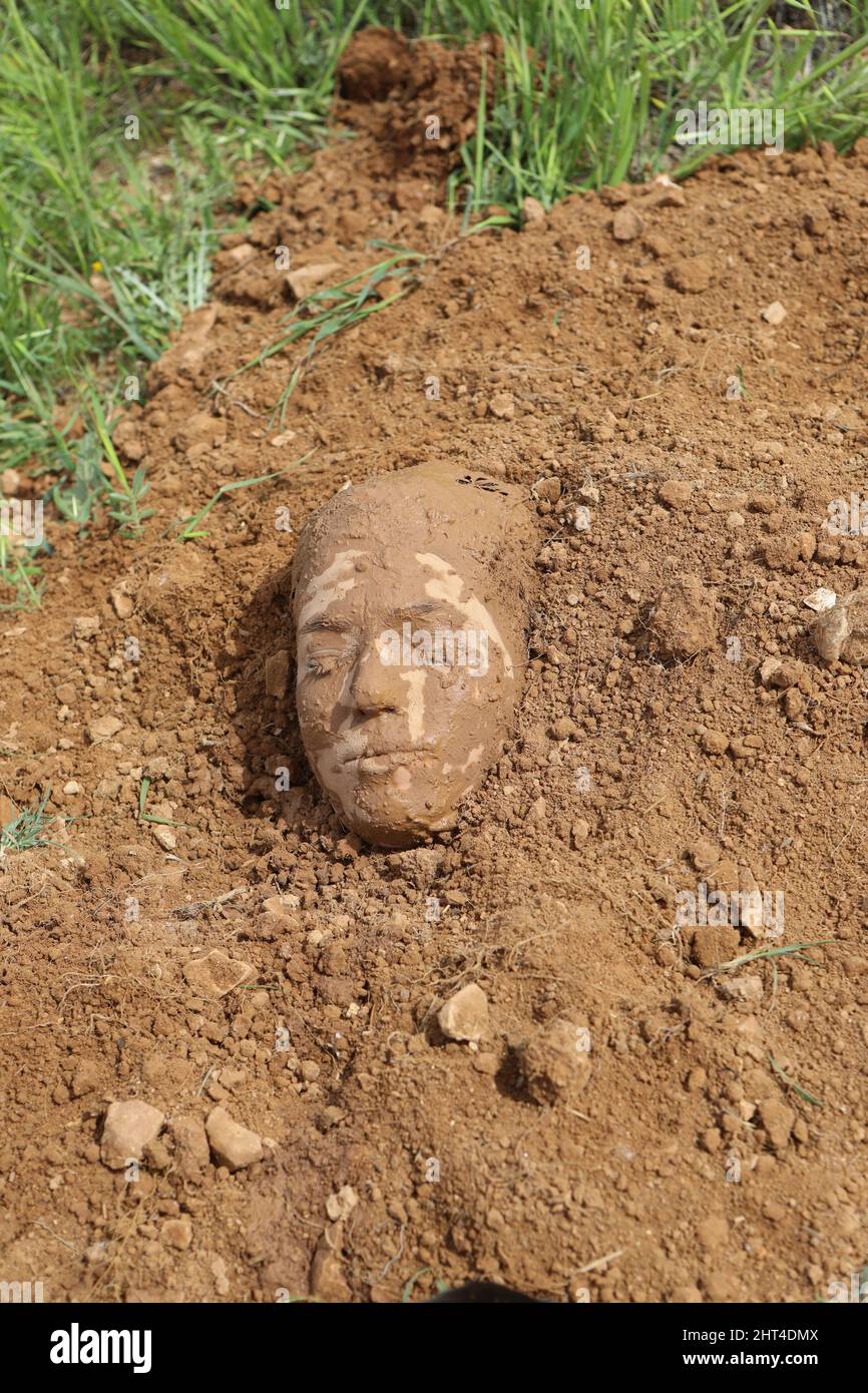 A woman buried in the ground A face covered in the ground Stock Photo ...