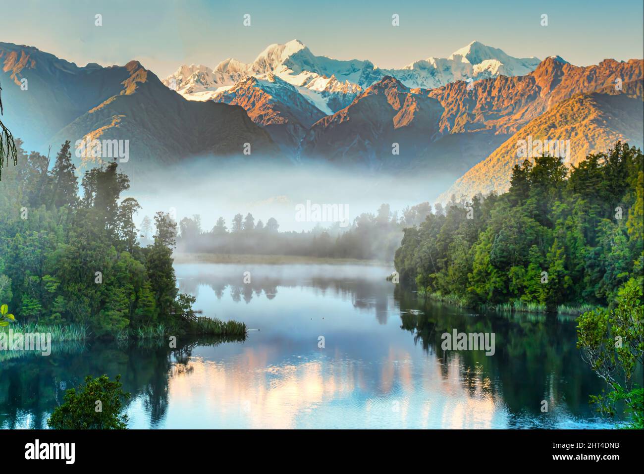 Early morning fog and mist at Lake Matheson but with enough light to ...