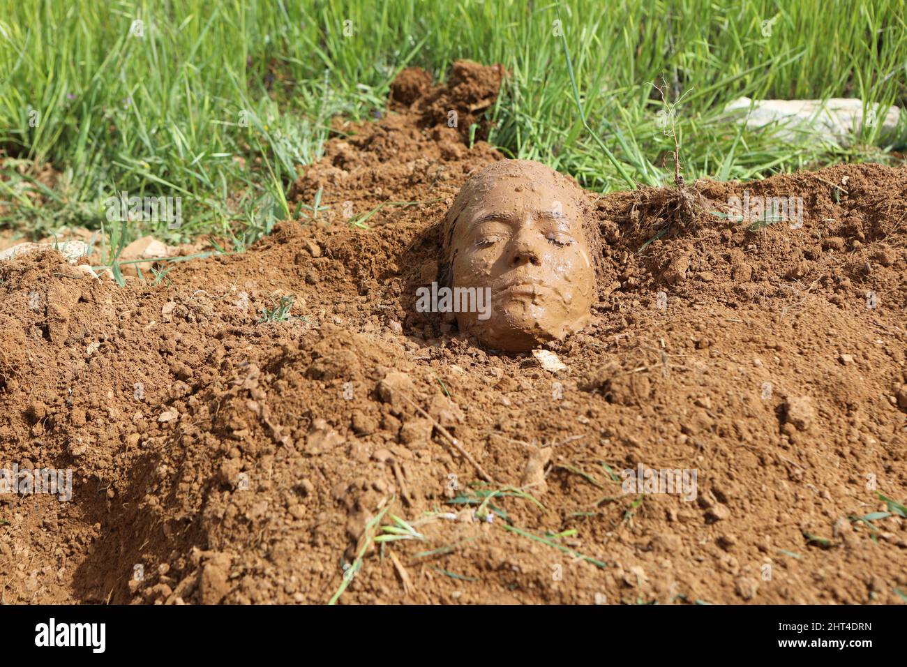 A woman buried in the ground A face covered in the ground Stock Photo ...