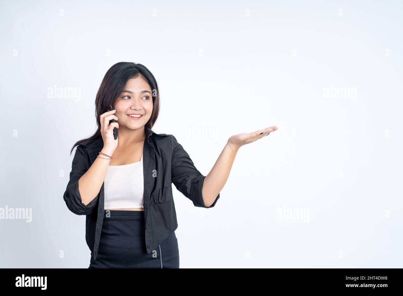 Young woman make a call with hand gesture presenting something Stock ...