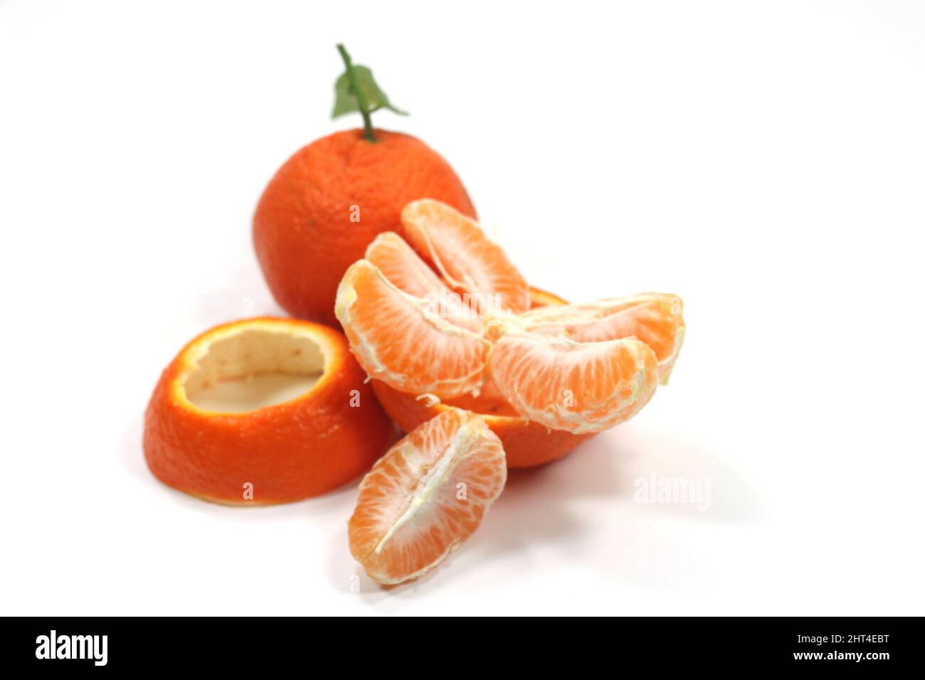 Closeup of peeled and sectioned tangerine fruit isolated on a white ...