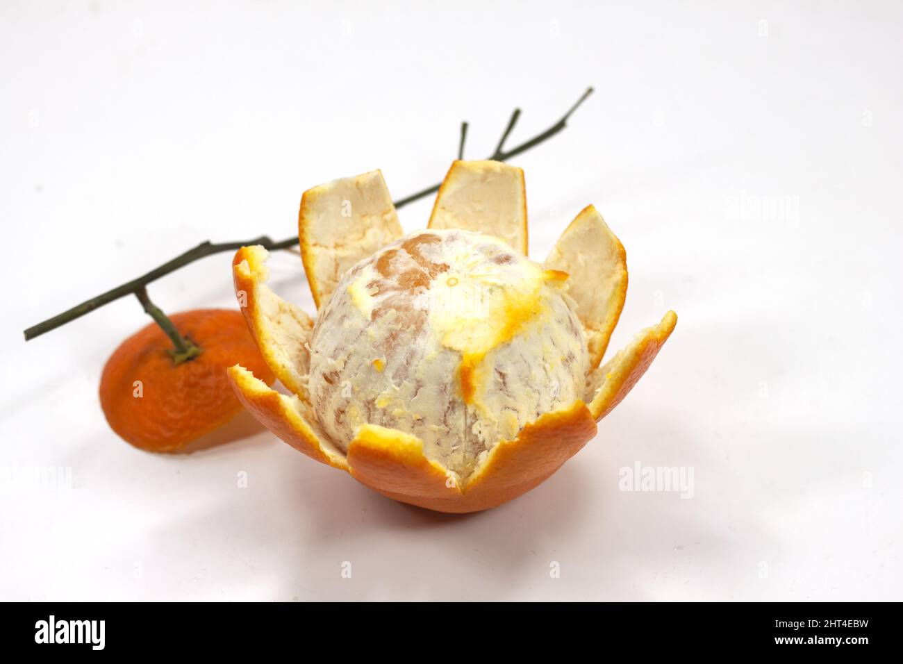 Closeup of peeled and sectioned orange fruit isolated on a white ...