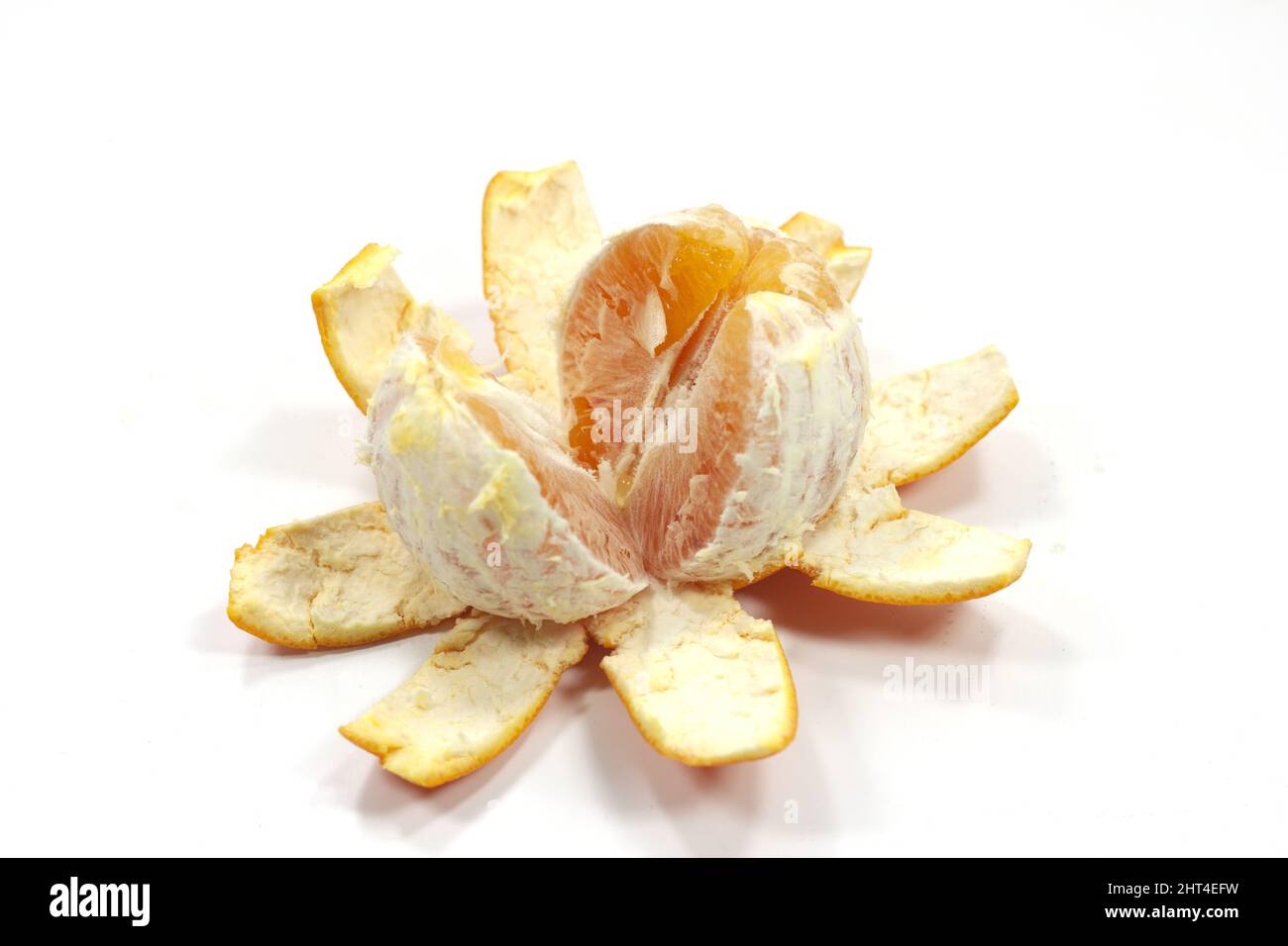 Closeup of peeled and sectioned orange fruit isolated on a white ...