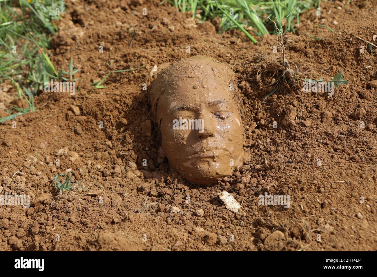 A woman buried in the ground A face covered in the ground Stock Photo ...