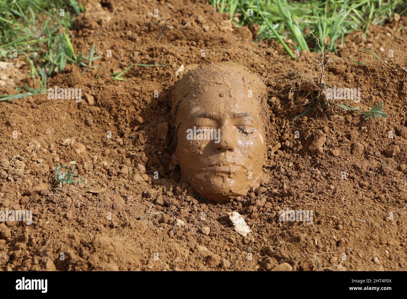 A woman buried in the ground A face covered in the ground Stock Photo ...