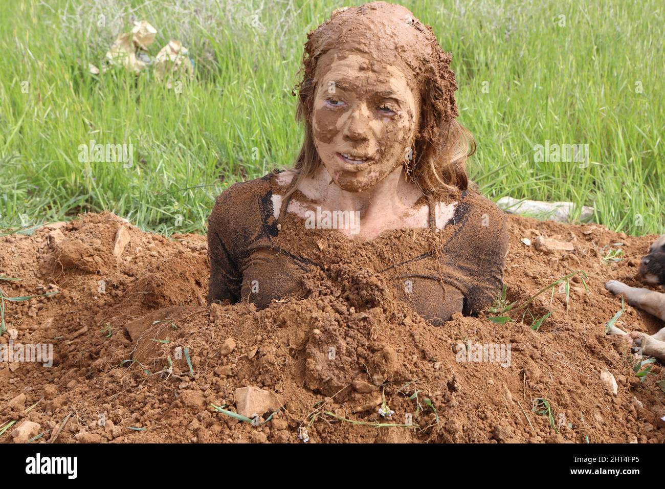 A woman buried in the ground A face covered in the ground Stock Photo ...
