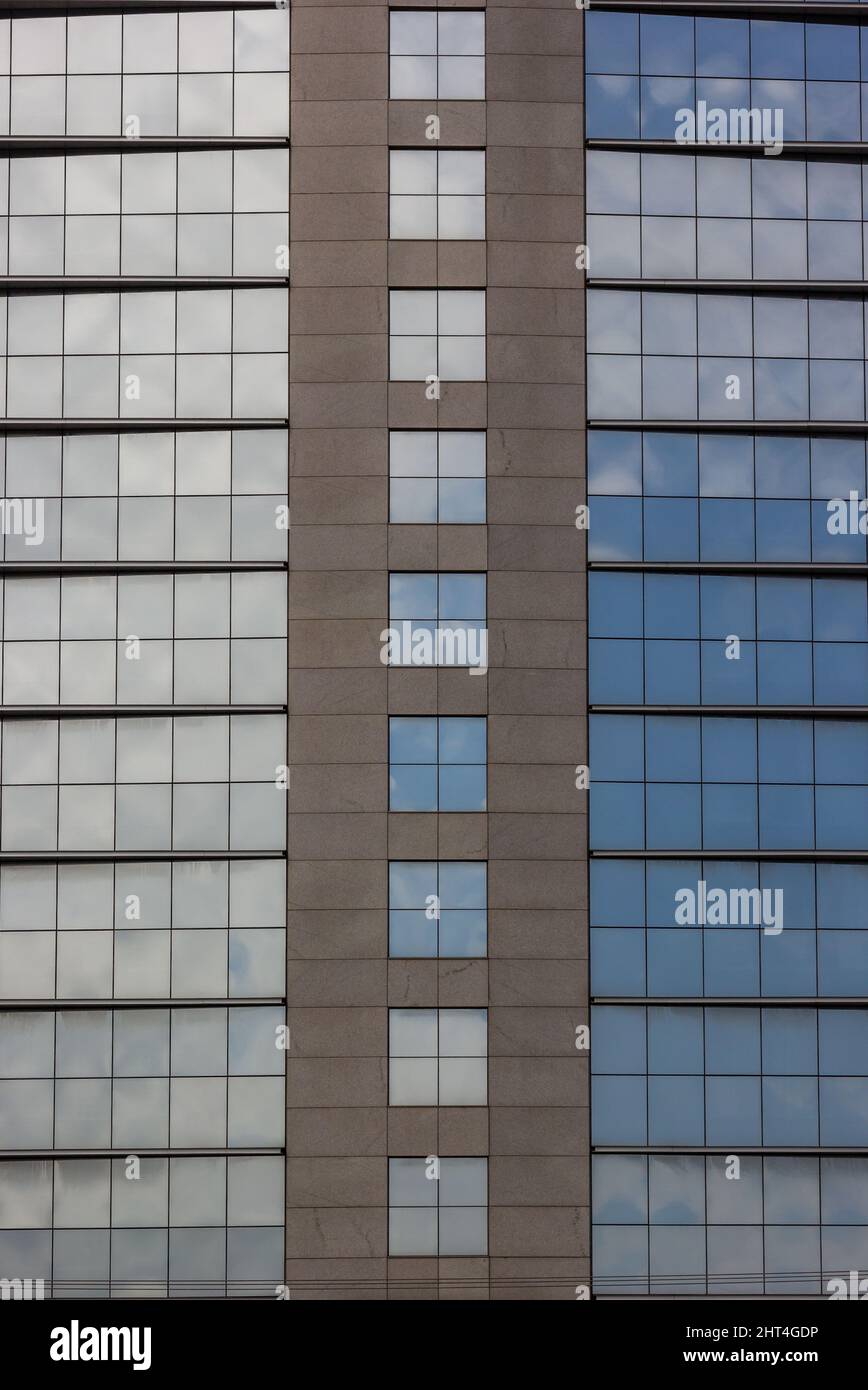Vertical shot of a modern building with glass windows Stock Photo - Alamy