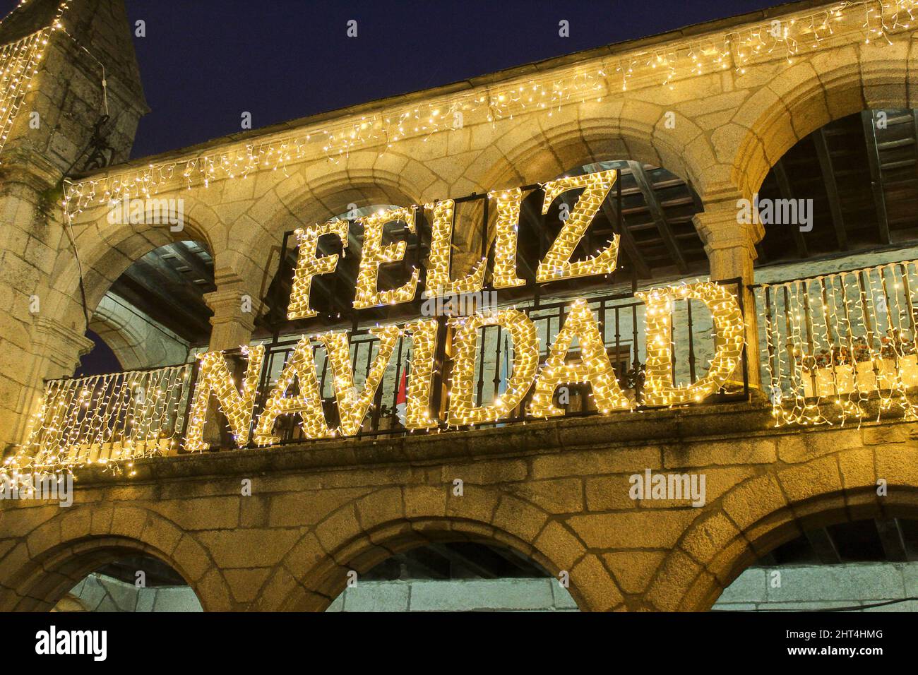 Closeup shot of the sparkly sign saying Merry Christmas in Spanish on a ...