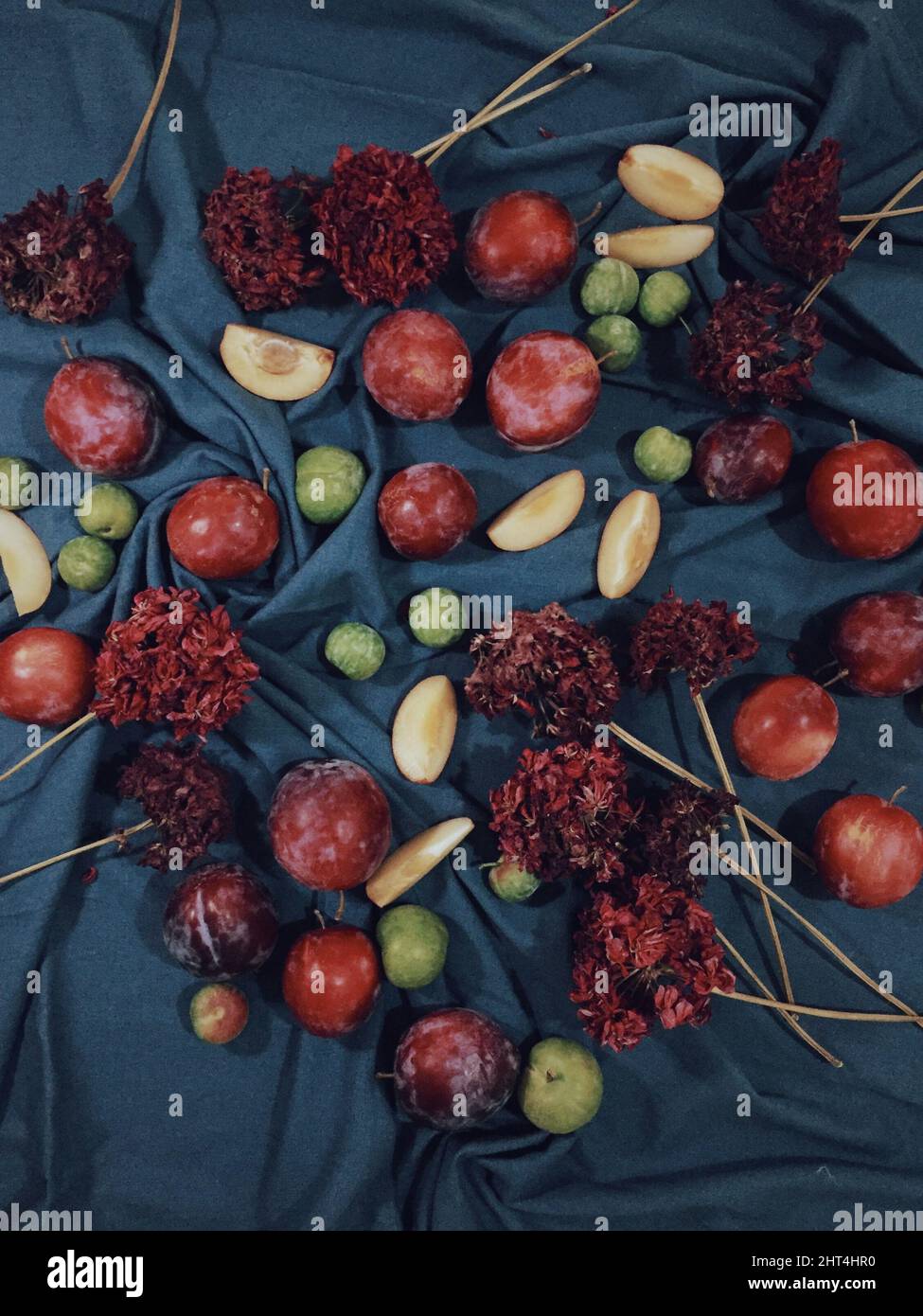 Aesthetic top view of colorful plum fruit and flowers composition on a ...