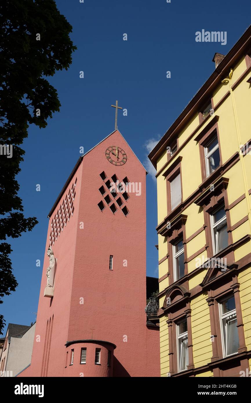 Church tower of the Catholic Church of St. Josef and the old yellow ...
