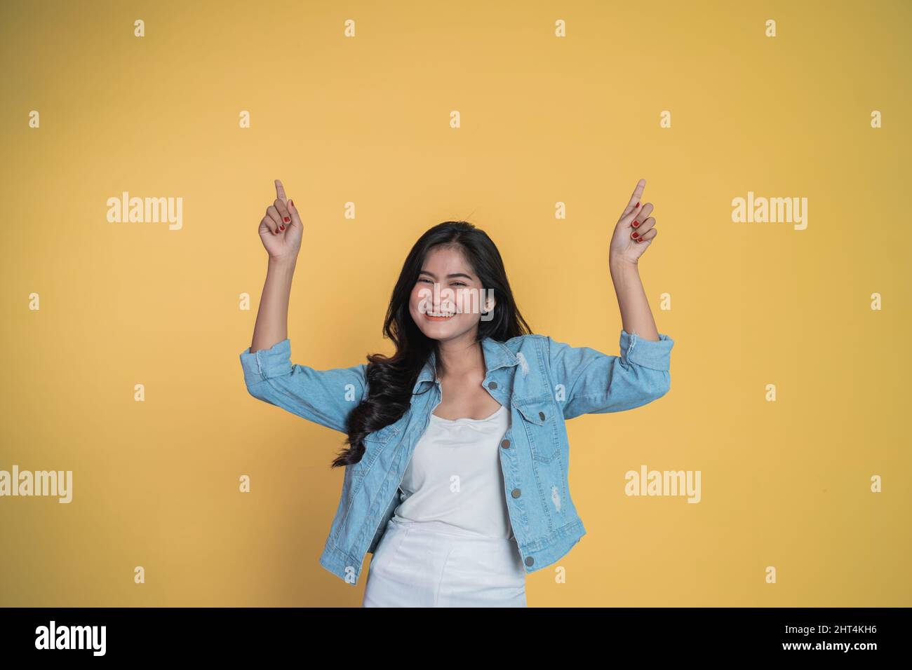 young woman with two finger pointing up Stock Photo - Alamy