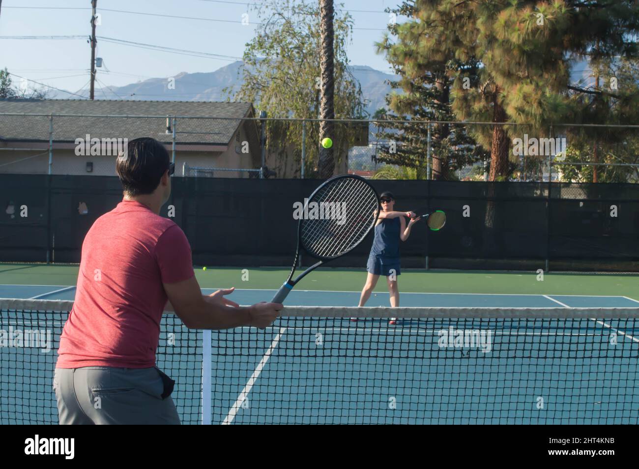 Caucasian men and women taking tennis lessons Stock Photo - Alamy